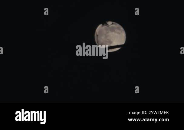 Dark Clouds moving quickly over Full Moon until it is completely ...