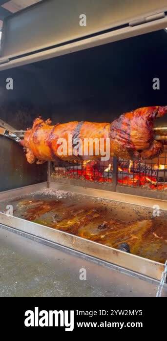 Rotisserie or spit-roasting pig, traditional food for Christmas ...