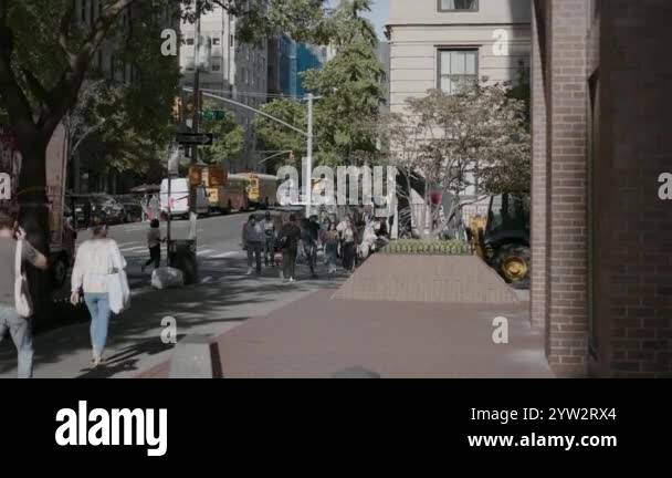 NEW YORK, USA - OCTOBER 31, 2024: A lively urban street vibrant with ...