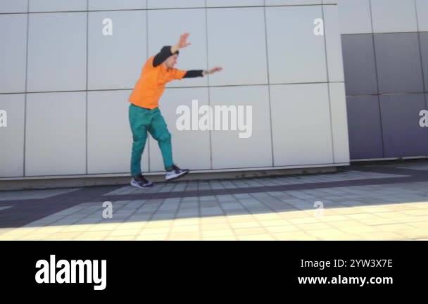 young acrobatic guy jumping back somersault and dancing break dance ...