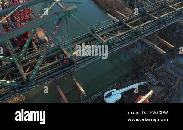 Above top view, dolly move on worker as cutting pillar of old railroad ...