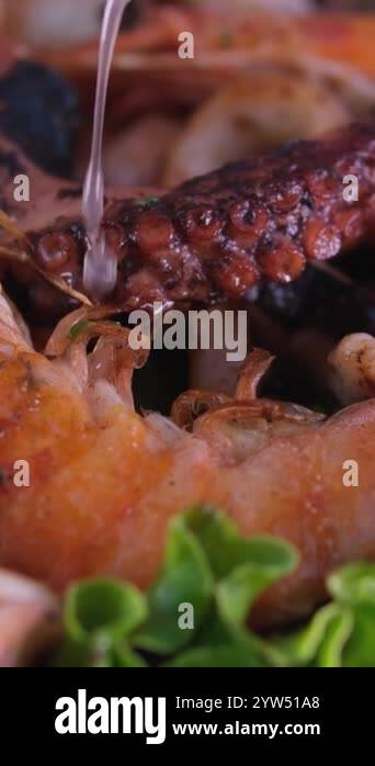shrimp octopus female cook in a black glove pours freshly squeezed ...