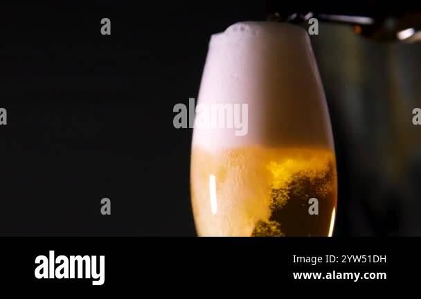 pouring beer into pint in motion. Filmed on high speed cinema camera ...