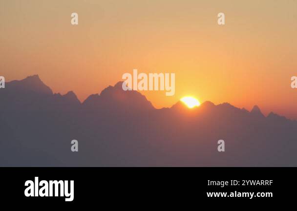 Dawn on the Himalaya mountain range. The golden sun rise behind the peaks in a clean morning sky ...