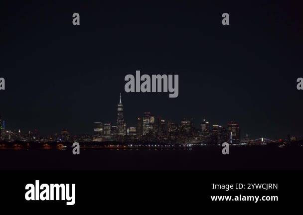 Stunning night view of Manhattan skyline showcasing brightly lit ...