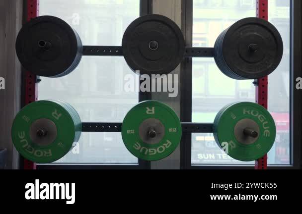 NEW YORK, USA - DECEMBER 2, 2024: Close-up of green weight plates ...