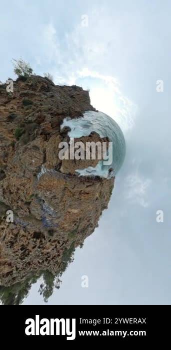Vertical video. "Tiny planet" effect showing a circular view of rocky ...