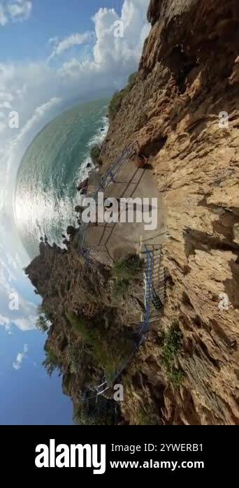 Vertical video. "Tiny planet" effect depicting a man walking toward the ...