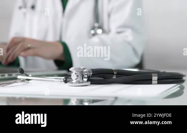 Stethoscope and medication history records form are lying on a glass ...