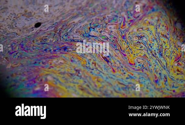 Abstract soap bubble. Gasoline leak. Defocused multicolor purple liquid ...