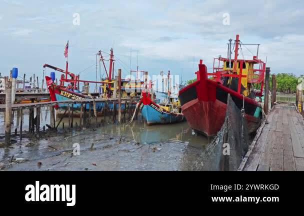 Perak,Malaysia.December 3,2024: Scene of the fishing boats docked by the concrete jetty after ...