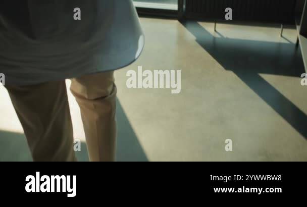 A close-up view of a persons legs and feet as they walk confidently ...