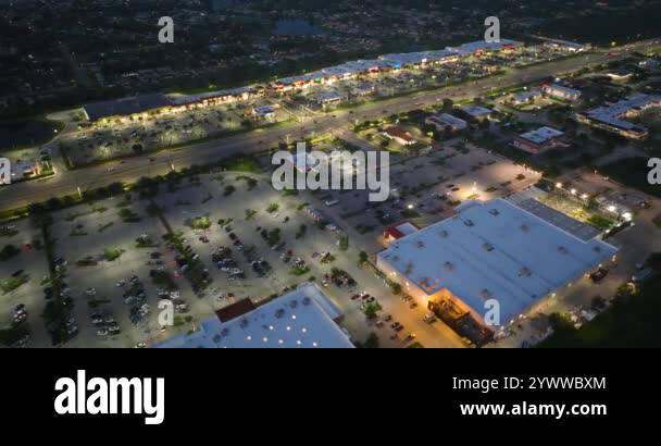 Shopping plaza stores and malls at night and American wide highway with ...