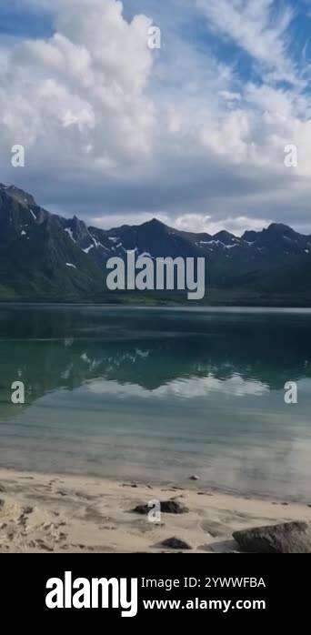 Gaze upon the tranquil waters mirroring the stunning peaks of Norway at ...