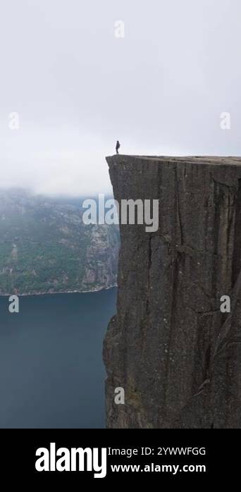 Discover the breathtaking experience of standing atop Preikestolen, a ...