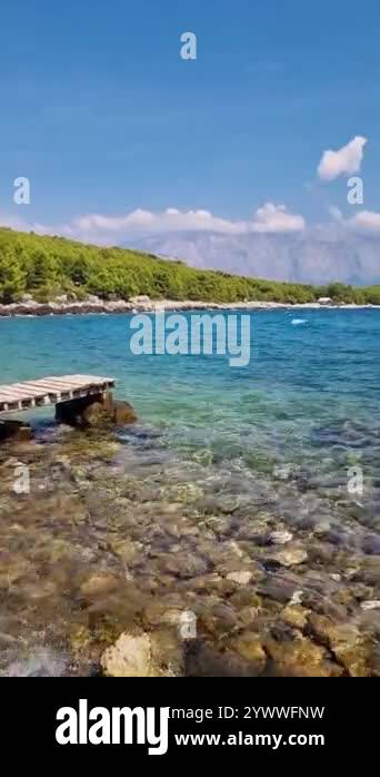 Bask in the beauty of a serene Adriatic beach where gentle waves lap ...