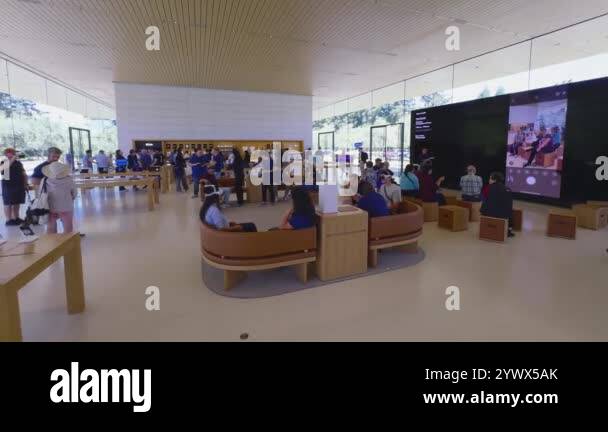 The video captures a spacious Apple Store interior with glass walls ...