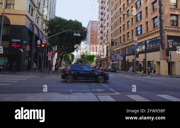 A bustling street in downtown Los Angeles features historic and modern ...