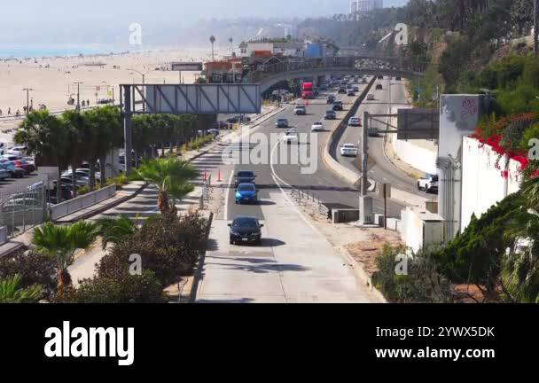A busy coastal highway in Los Angeles with palm trees, beach, and Santa ...