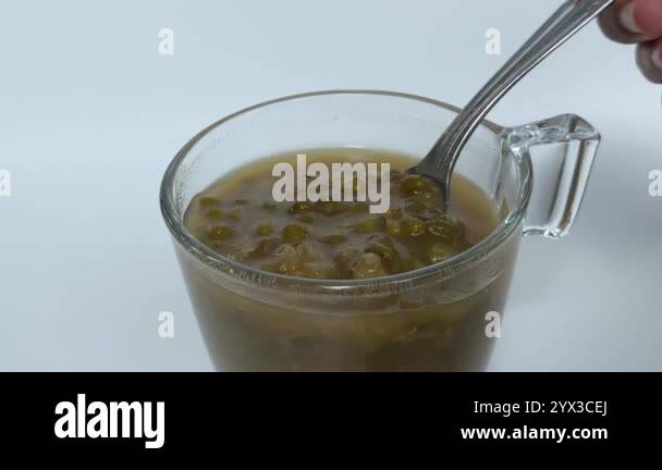 Mung beans drinks in a transparent glass, made by boiling green beans ...
