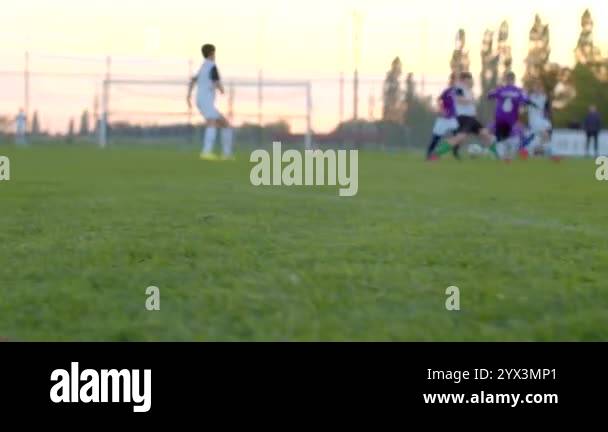 camera movement bokeh effect, players playing football on the field Enthusiastic youth soccer ...