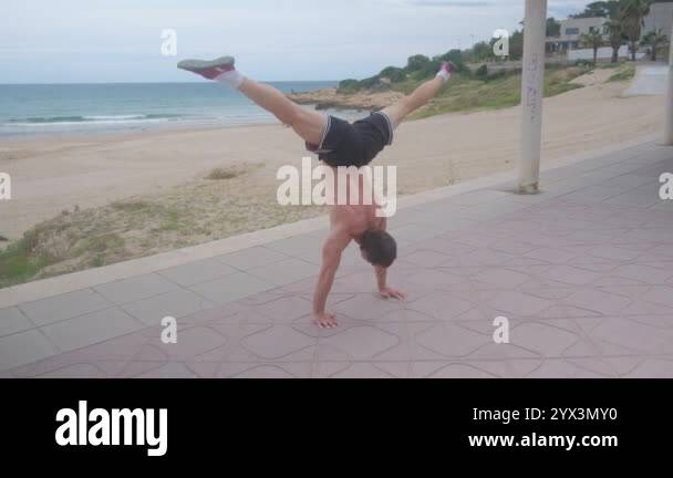 A muscular man in a handstand position, showcasing his exceptional ...