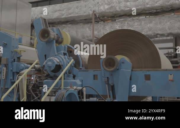 Process of winding cardboard sheet into rolls on large slitting machine ...