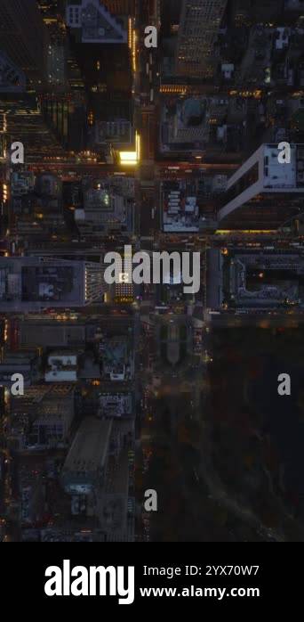 Aerial views capture traffic flowing through vibrant streets of New York City at night in slow ...