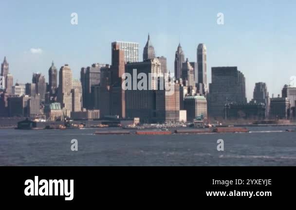 Manhattan skyscrapers viewed from the sea, with a blue sky and sunny ...