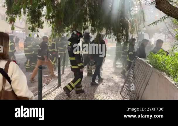 Angry crowd of firefighters are rallying in front of the city ...