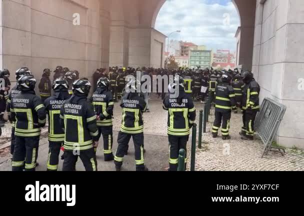 Angry crowd of firefighters with signs are rallying in front of the ...