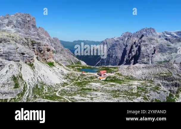 Tourists enjoying breathtaking views while hiking near the tre cime di ...