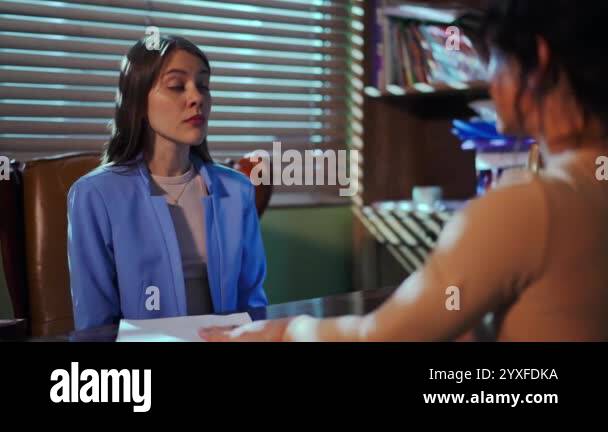 An intense interview between two women in a modern office reveals deep ...