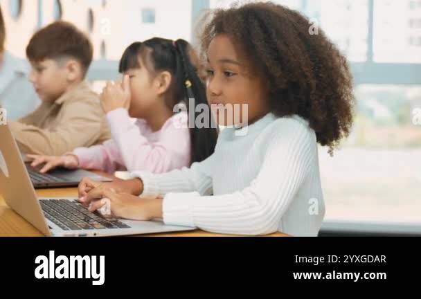 African girl play laptop with diverse friend learning prompt at STEM technology class ...