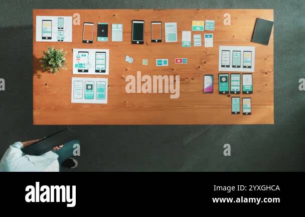 Top view of skilled developer walking and placing Ux Ui software. Smart ...