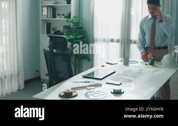 Top down aerial view of smart engineer calling manager about turbine ...