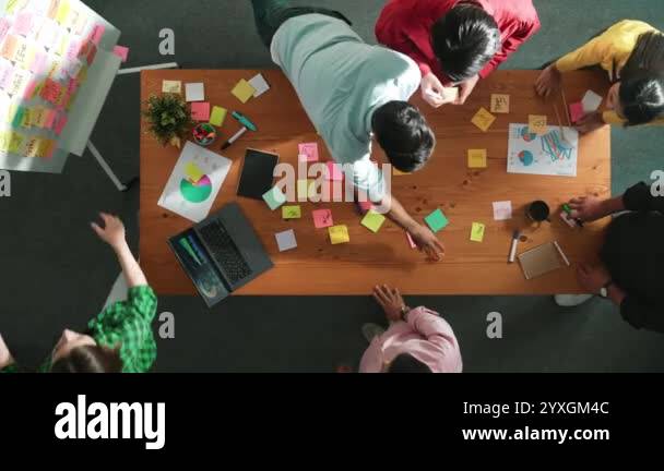 Top down aerial view of business team brainstorming idea and writing ...