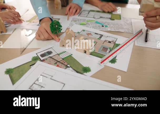 Architects determine position of tree or house using building blueprint ...
