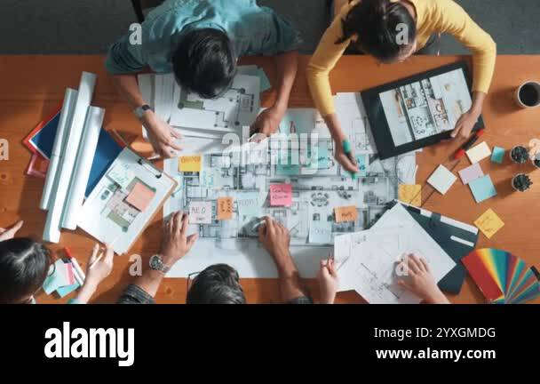 Top down aerial view of civil engineer hold project plan while design ...
