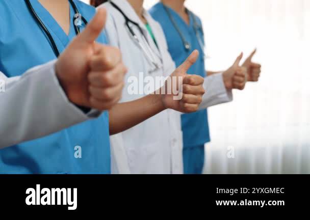 Professional team of medical staff stand in line together and thumbs up ...