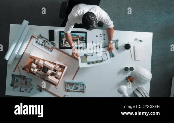 Top view of business man using tablet plan house design while sitting ...