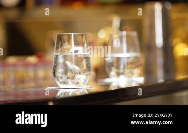 Serving welcome refreshing drink of fizzy tonic or soda with cube ice ...
