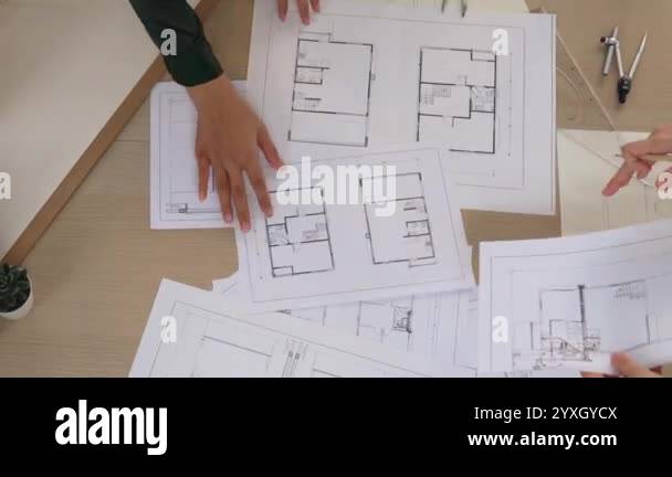 Interior designer drafting blueprint with customer supervise and ...