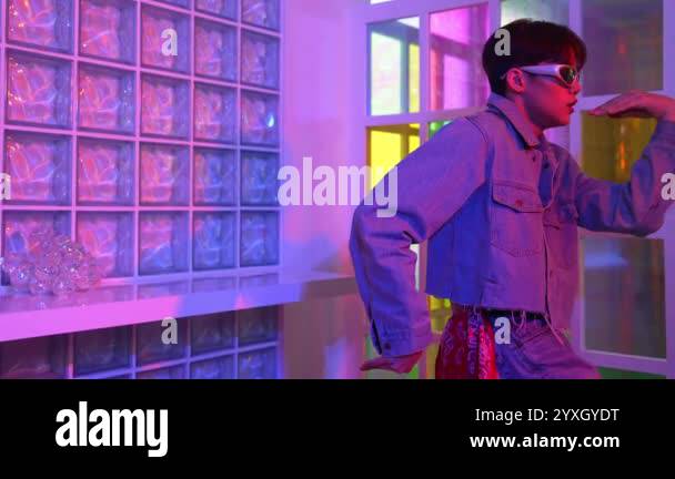 Happy dancer moving hands to hip hop music and standing at nightclub ...