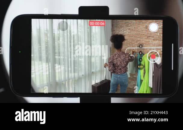 Rear view behide smartphone screen recording woman influencer shoot ...