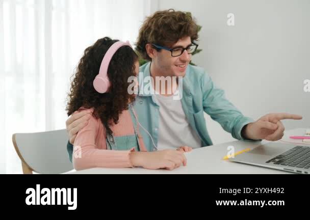 American daughter learning to coding and writing engineering prompt while positive smart father ...