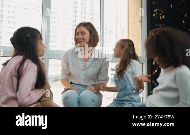Teacher and diverse students putting hands together at classroom. Young ...