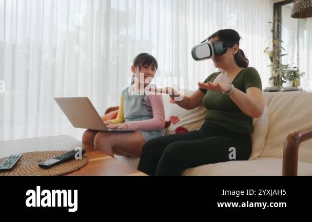 Granddaughter control laptop guide grandmother to dive in metaverse with VR. Senior adapt to ...