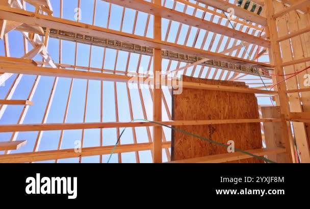 An open roof structure of wooden beams with progressing structural ...