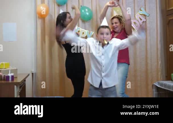 Celebrating a child's birthday, people dance, play and have fun ...